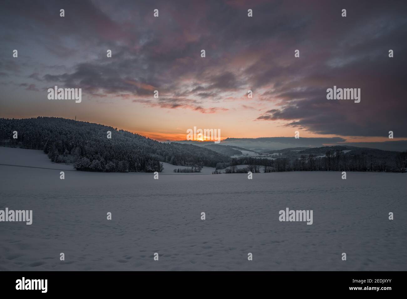 Landscape during sunset in winter with snow and ice and mountains in ...