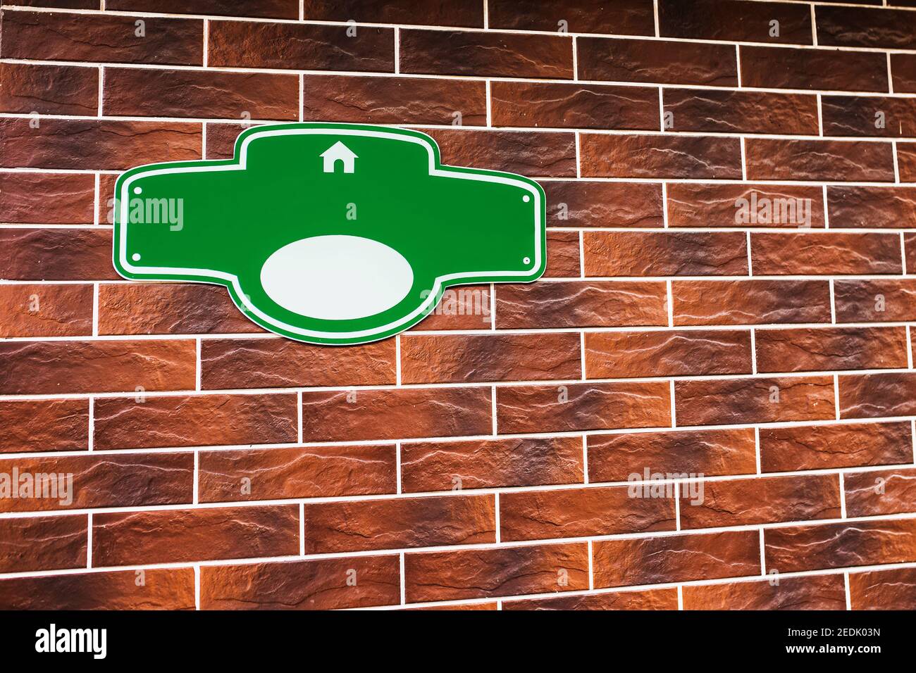 Green plaque for house number on a brick wall - address sign - place ...