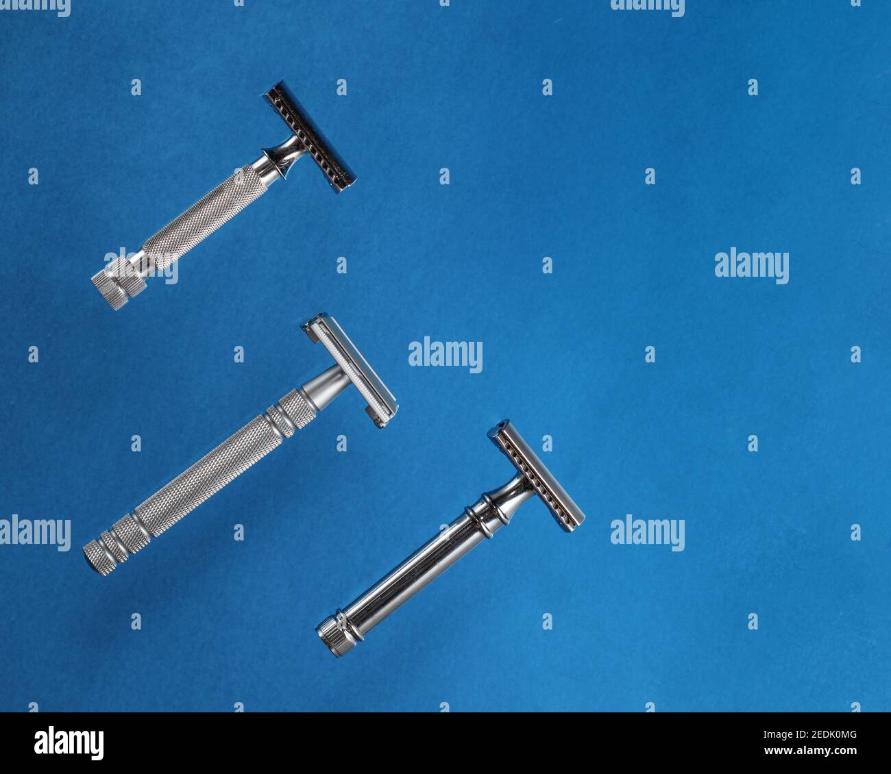 three razors on blue background. View from above Stock Photo - Alamy