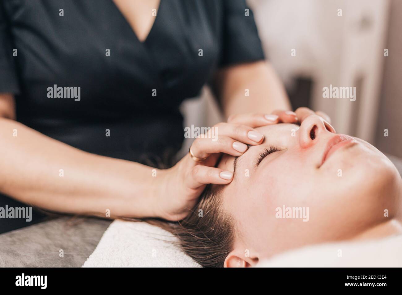 Technique for performing a facial massage in a beauty salon - hands of ...