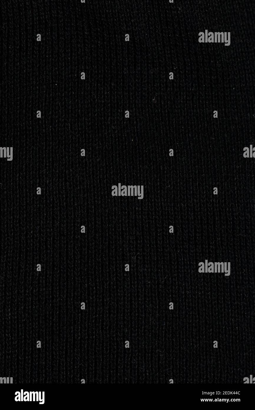 black fabric surface, small stitches as background. Structure of dark ...