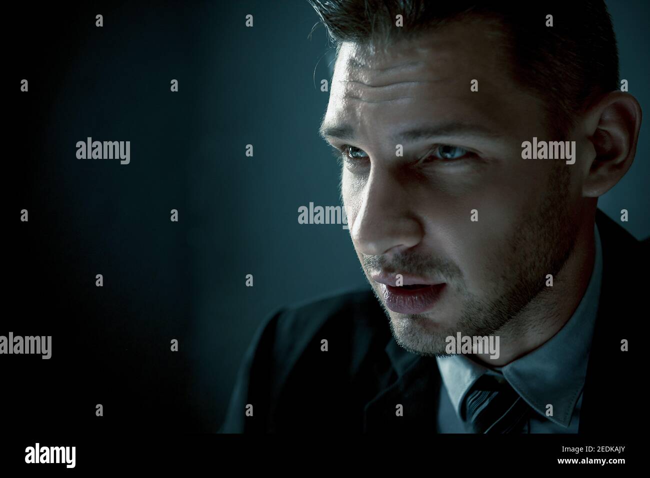 Man in shadow with serious face staring at interlocutor in ...