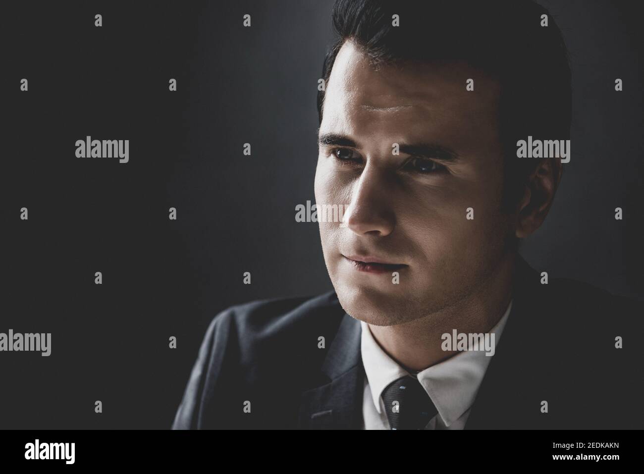 Man in shadow with serious face staring at interlocutor in ...