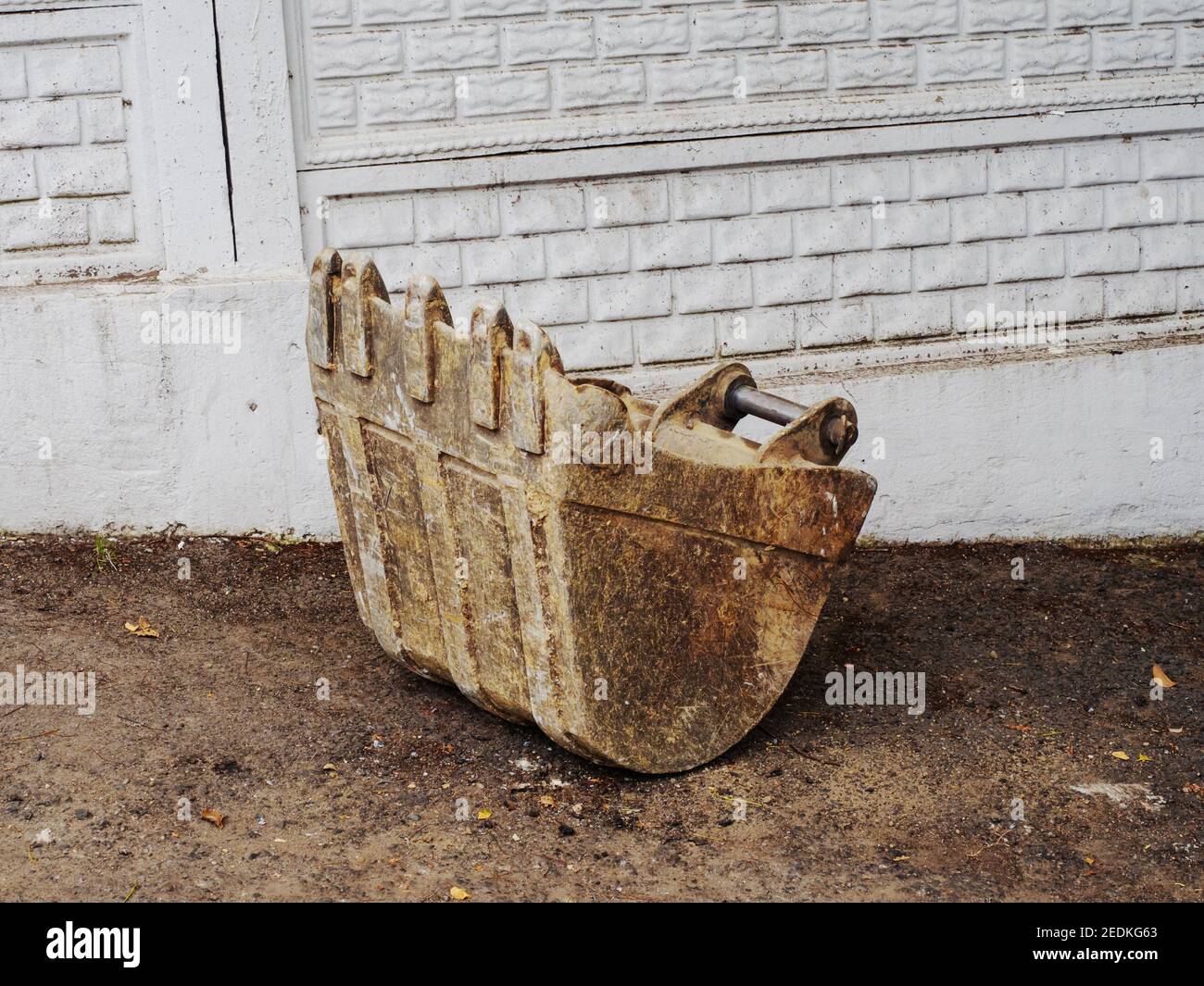 Old dirty excavator bucket lies on the ground in street Stock Photo - Alamy