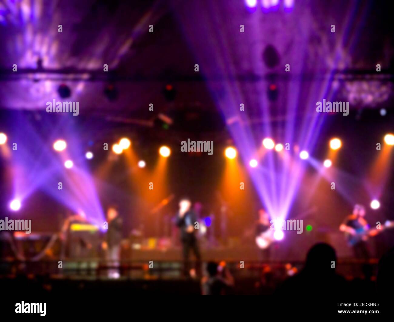 Blurred rock concert performing on stage with musician with red light ...
