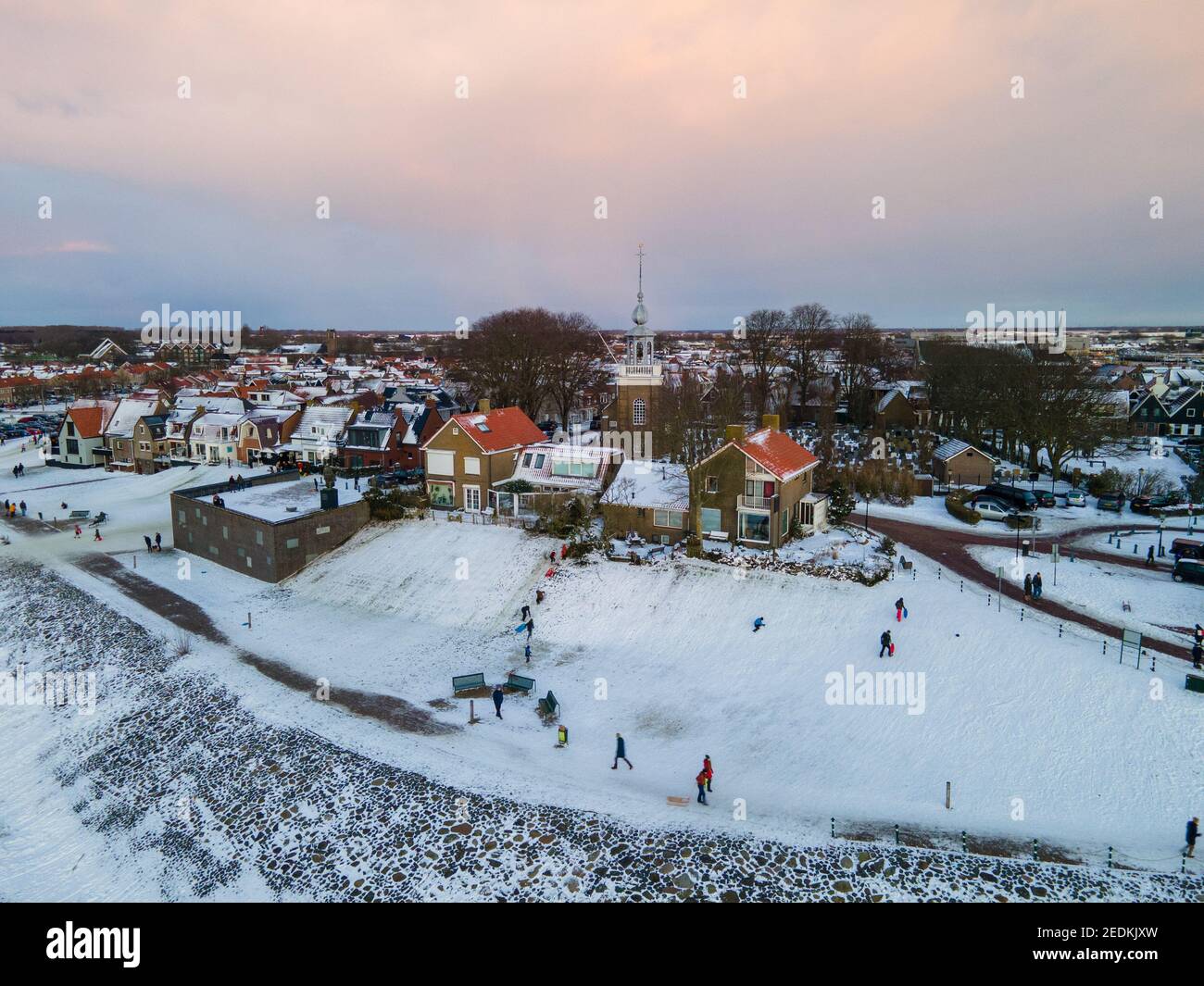 snow covered beach during wnter by Urk lighthouse in the Netherlands ...