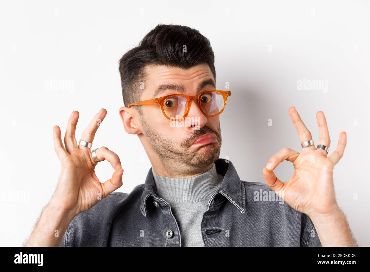 Not bad. Impressed man in stylish glasses showing okay signs and nod in ...