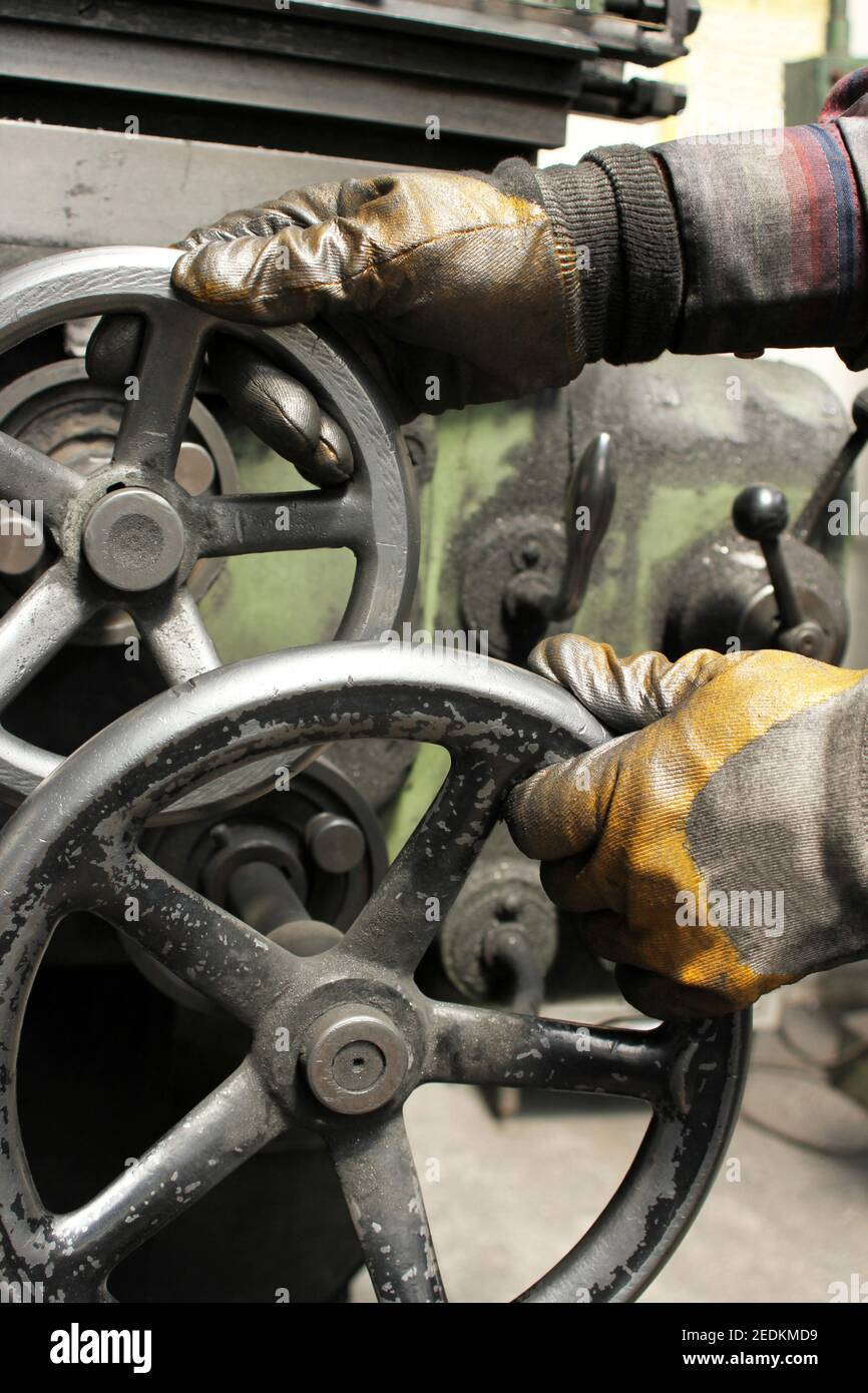 Lathe machine and steel worker Stock Photo - Alamy