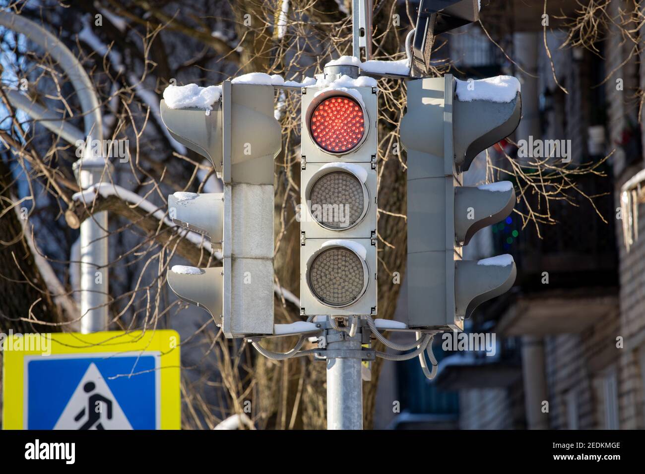 traffic lights with a red traffic signal on the street of the city ...
