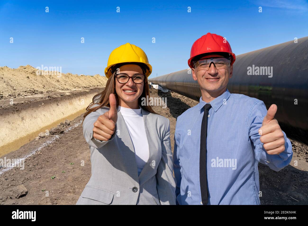Smiling Man and Woman in Hardhats With Thumbs Up at Gas Pipeline ...