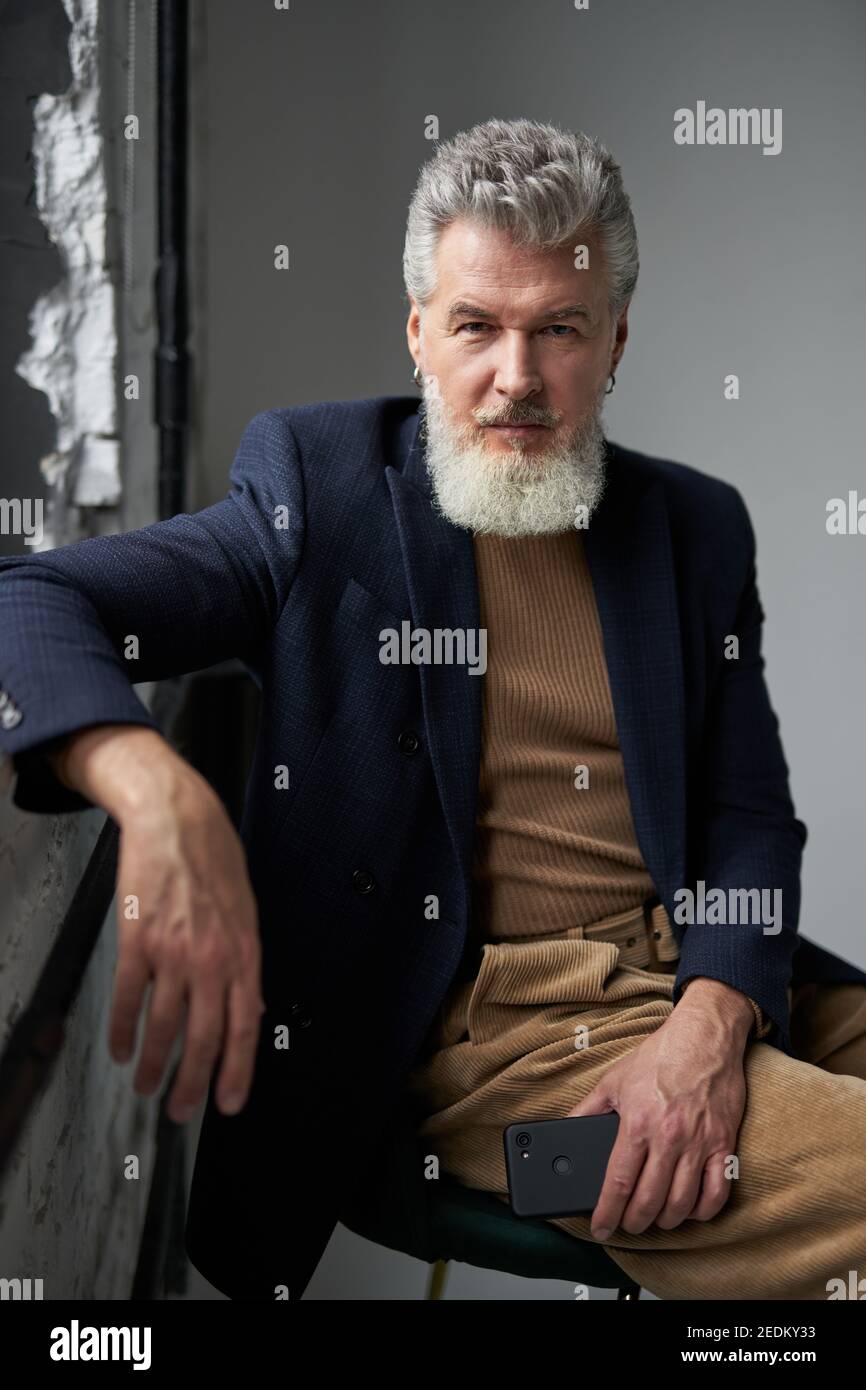 Stylish middle aged man in business casual wear looking at camera ...