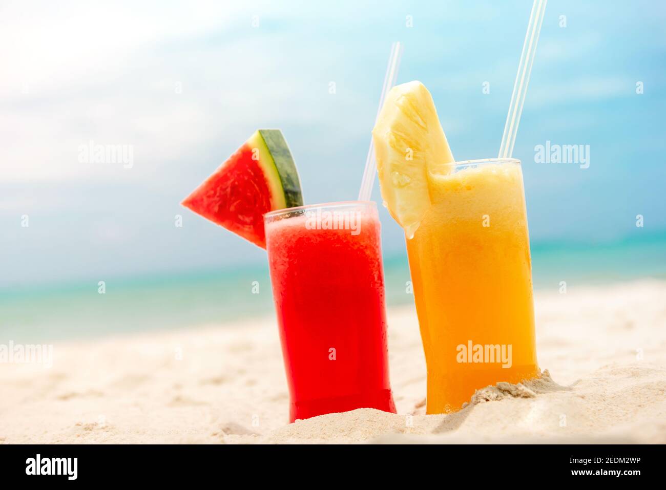 Colorful refreshing cold tropical fruit smoothie drinks in summer white ...