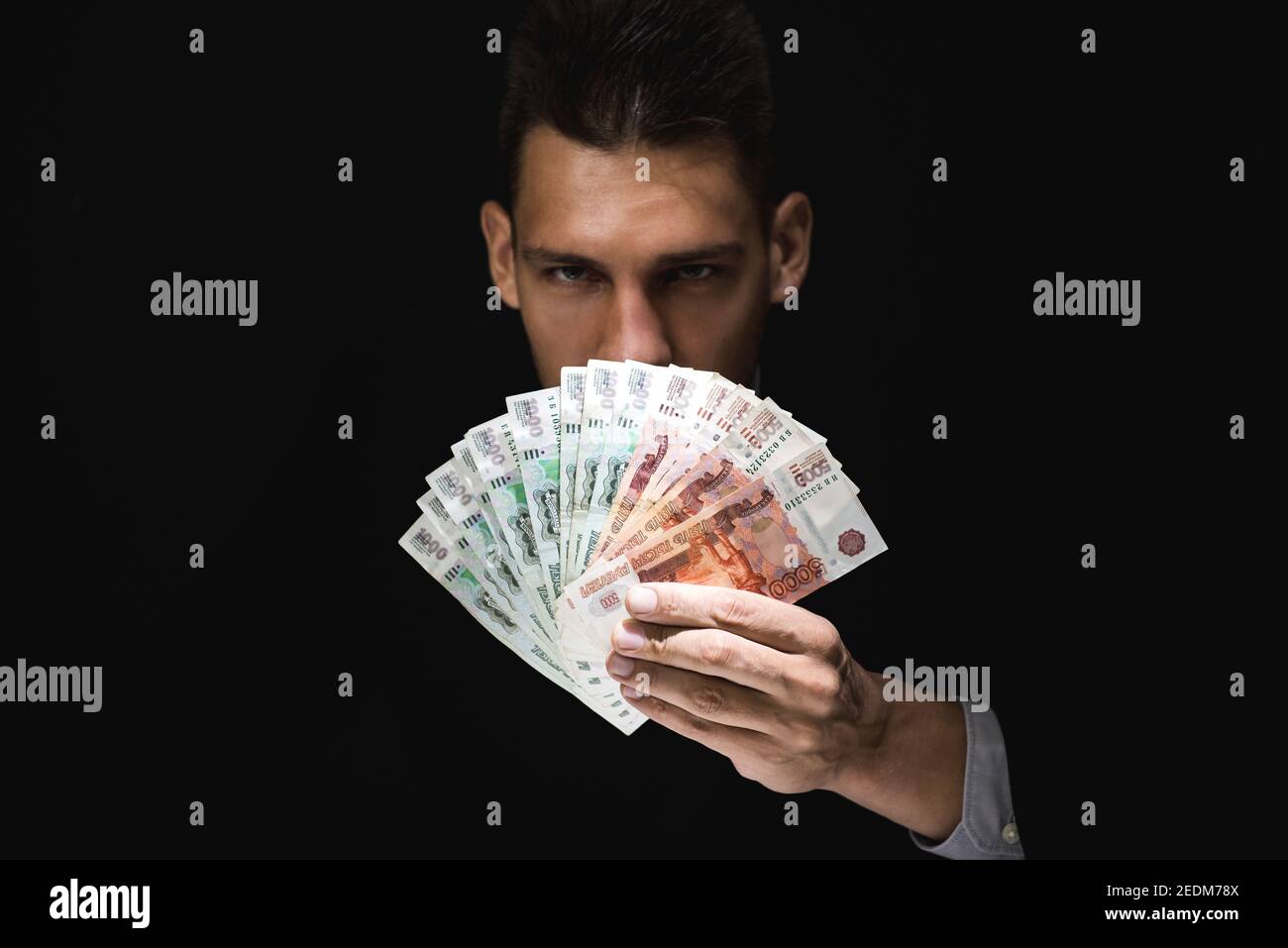 Mysterious man showing money, Russian Ruble currency banknotes, in the ...