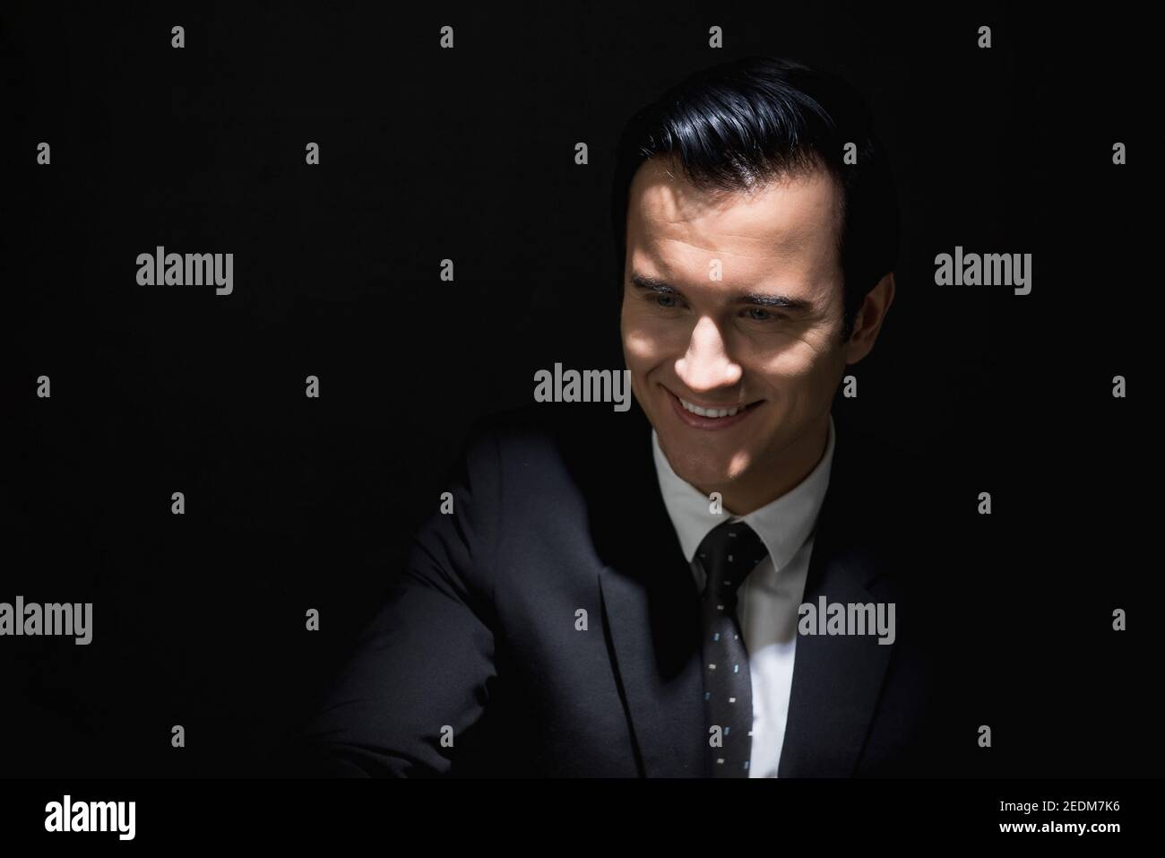 Man in shadow with smiling cunning face staring at interlocutor Stock ...