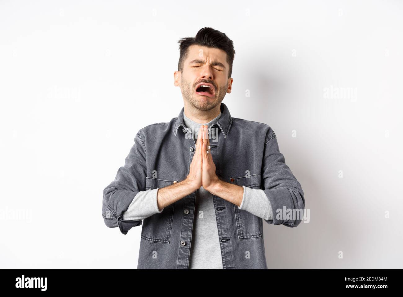 Miserable man begging for help, need something and crying, pleading ...