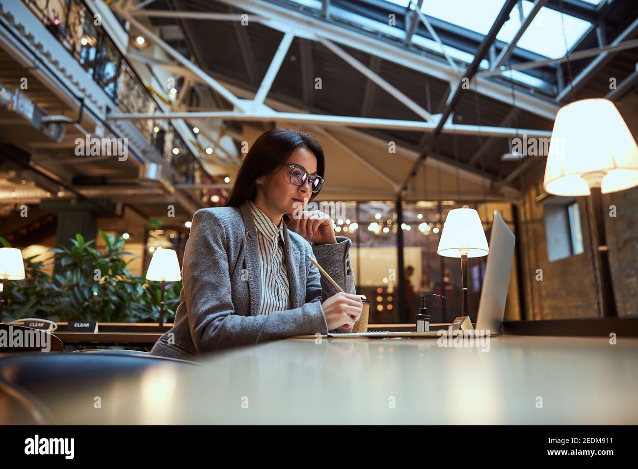 Attentive female person making notes during work Stock Photo - Alamy