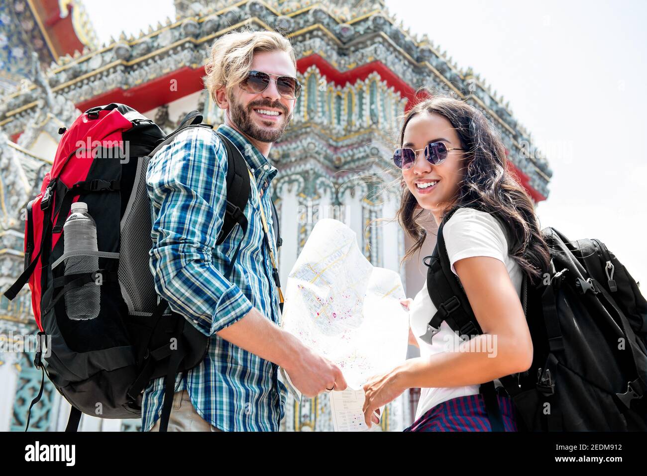 Young tourist couple backpackers traveling in ancient Thai temple on ...