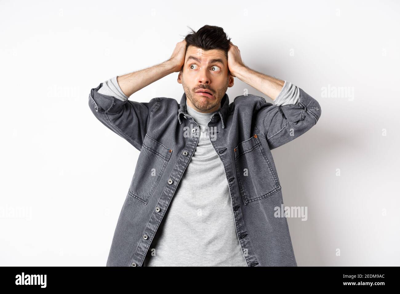 Guy looking aside in panic, stare at logo nervous and alarmed, having ...