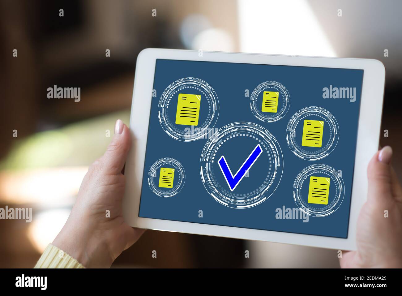 Tablet screen displaying a document validation concept Stock Photo - Alamy