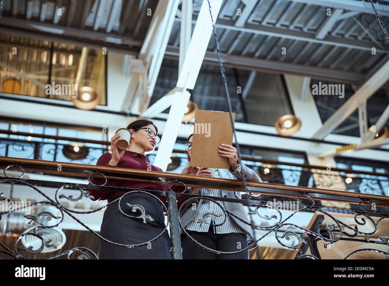 Attentive Asian female looking at schedule for day Stock Photo - Alamy