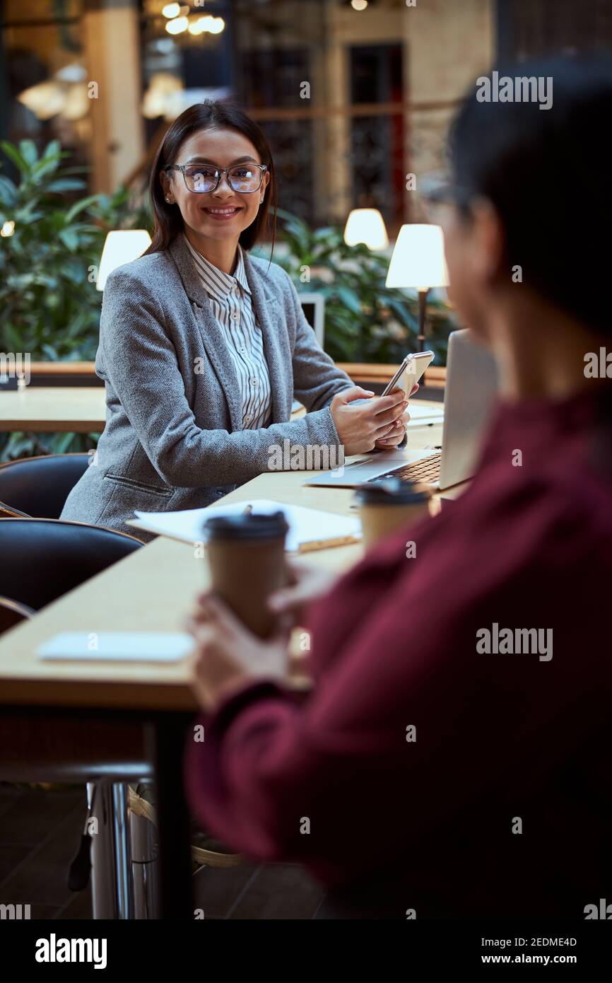 Positive delighted female listening to her partner Stock Photo - Alamy