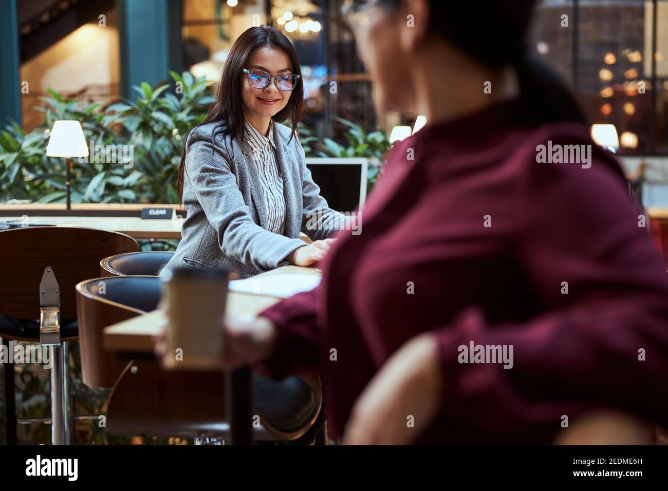 Joyful young office worker staring at her laptop Stock Photo - Alamy