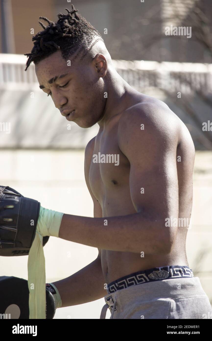 Open image of panoramic young black boxer without T-shirt putting ...