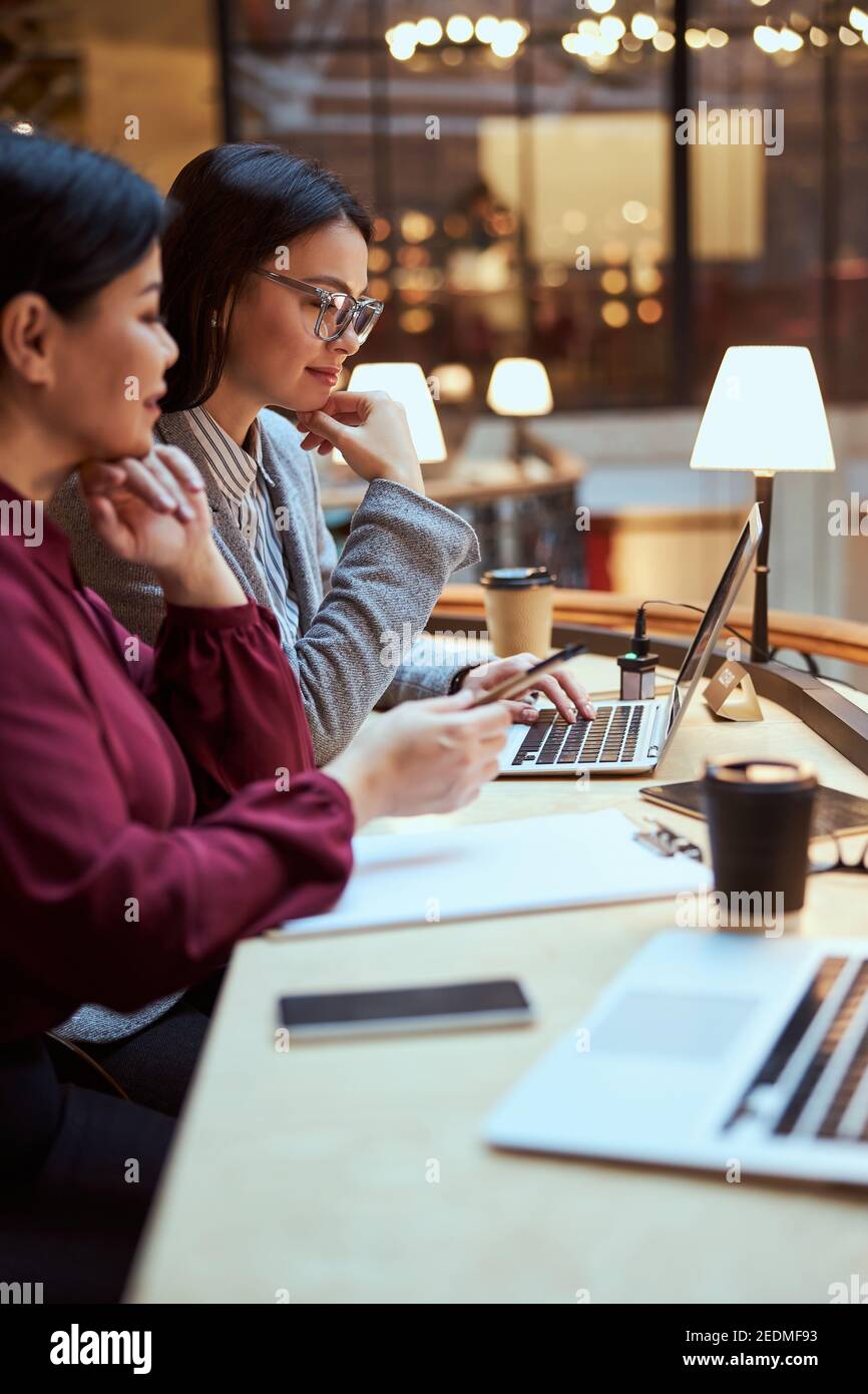 Concentrated females staring at screen of their laptop Stock Photo - Alamy