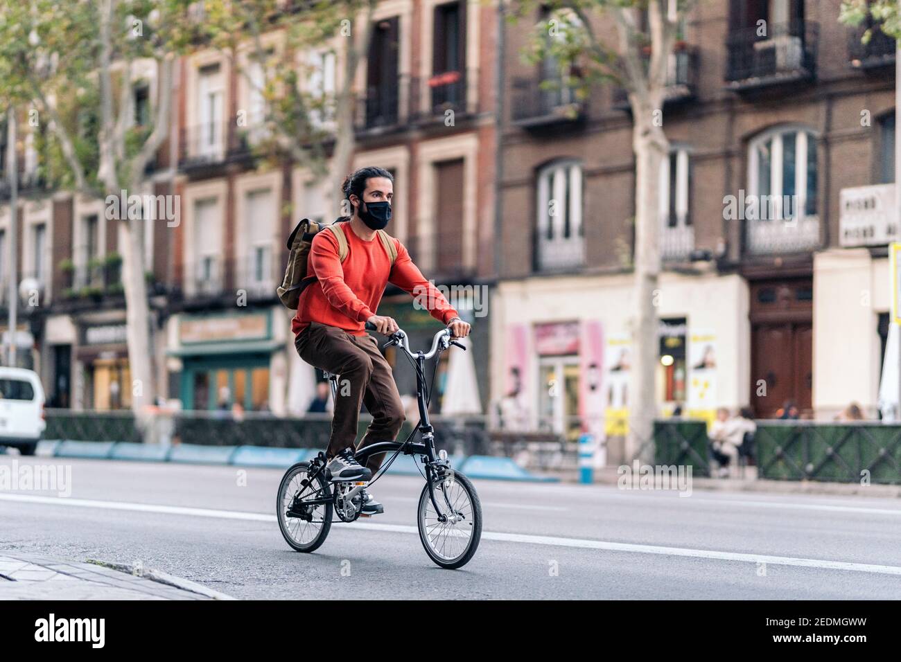 Stock photo of bearded man riding his detachable bike in the street ...