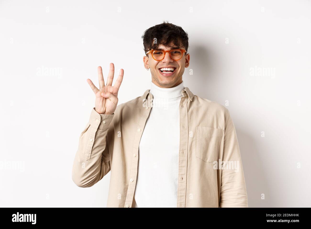Handsome young man making order, showing number four fingers and ...