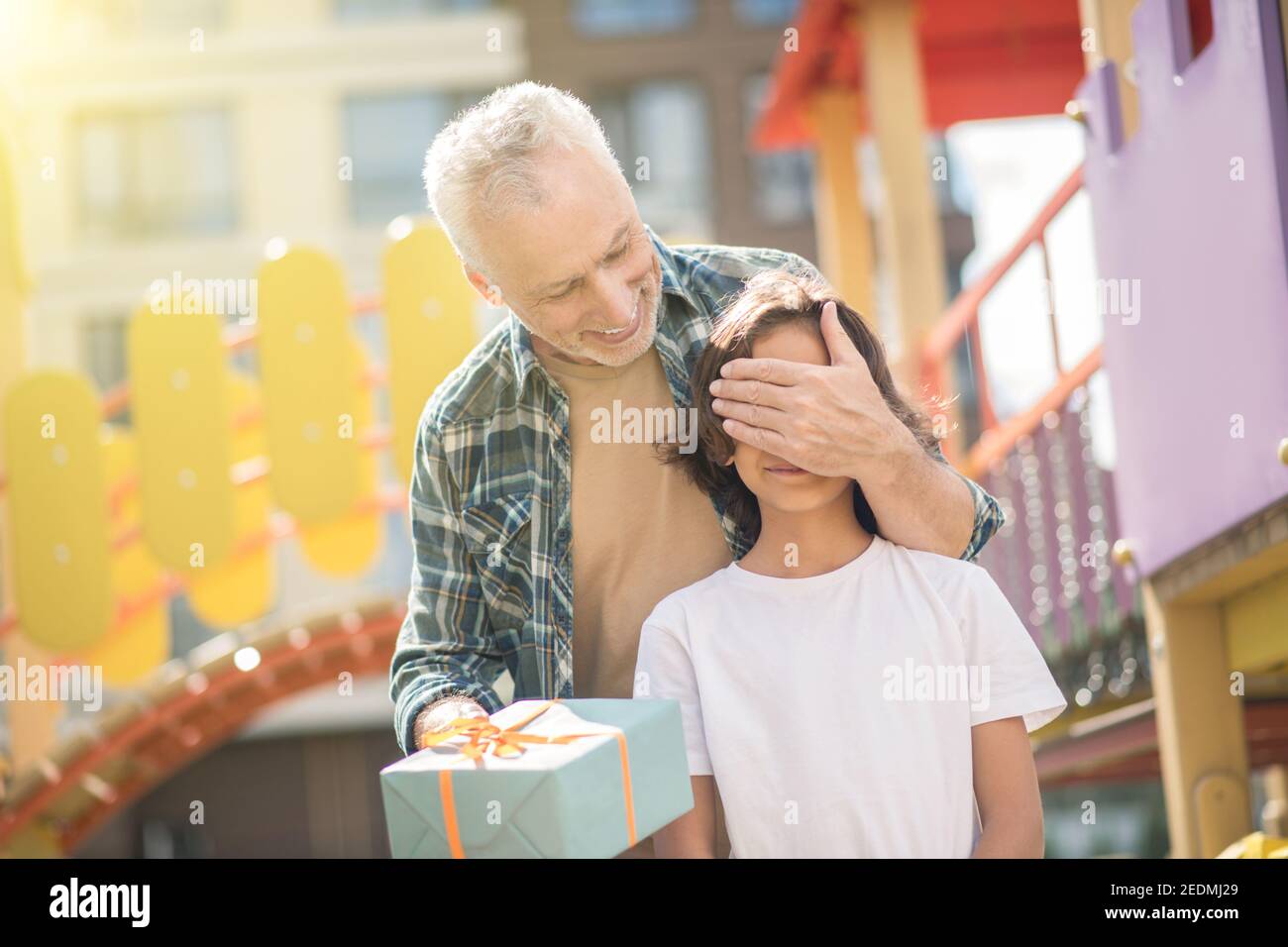 Happy father giving a gift to his son and both looking excited Stock ...