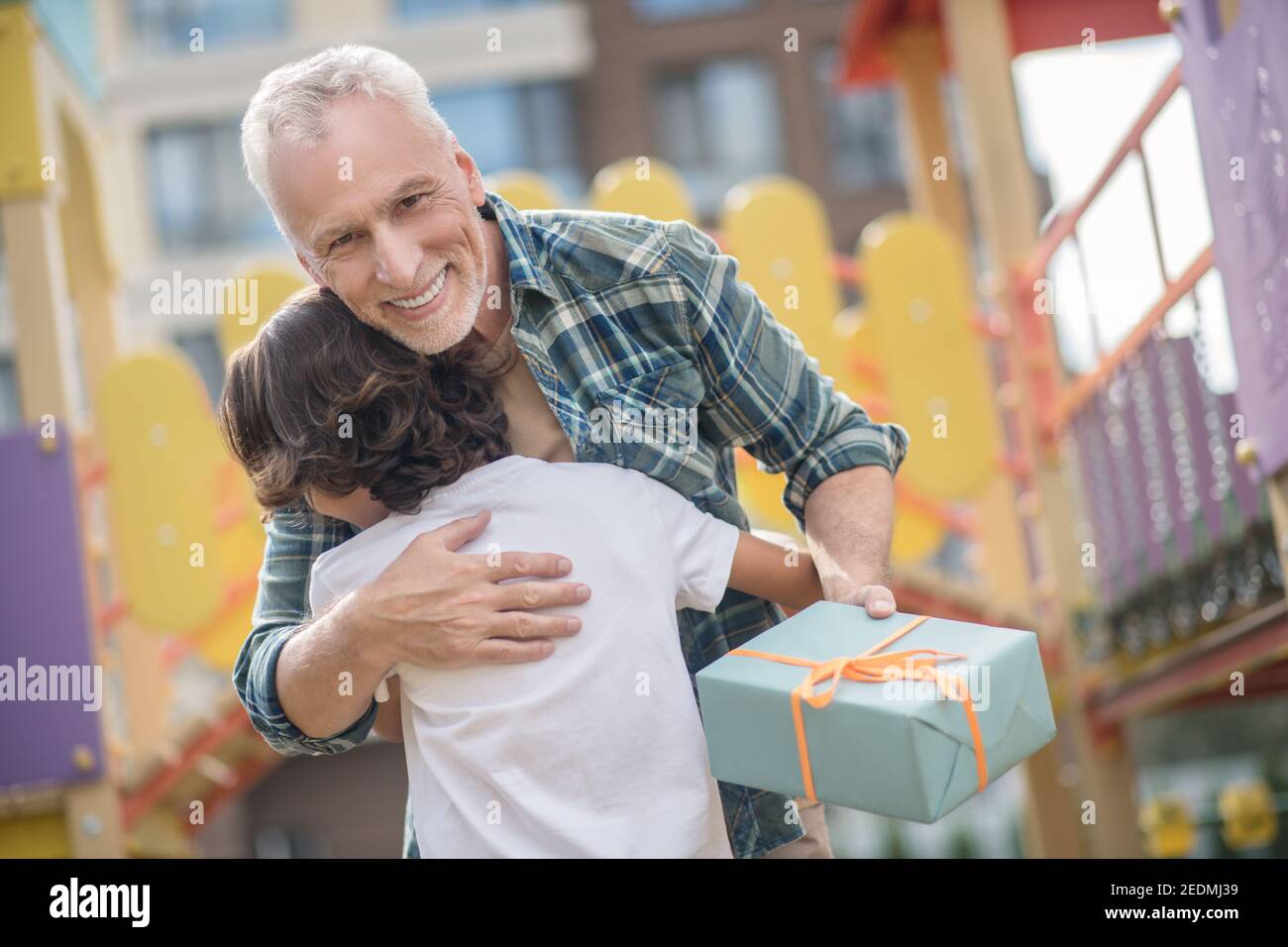 Happy father giving a gift to his son and both looking excited Stock ...