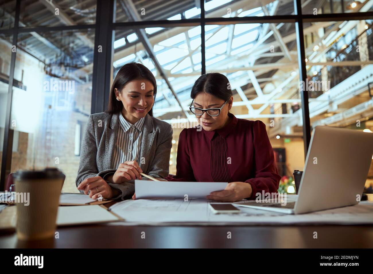 Two competent designers discussing changers in drawing Stock Photo - Alamy