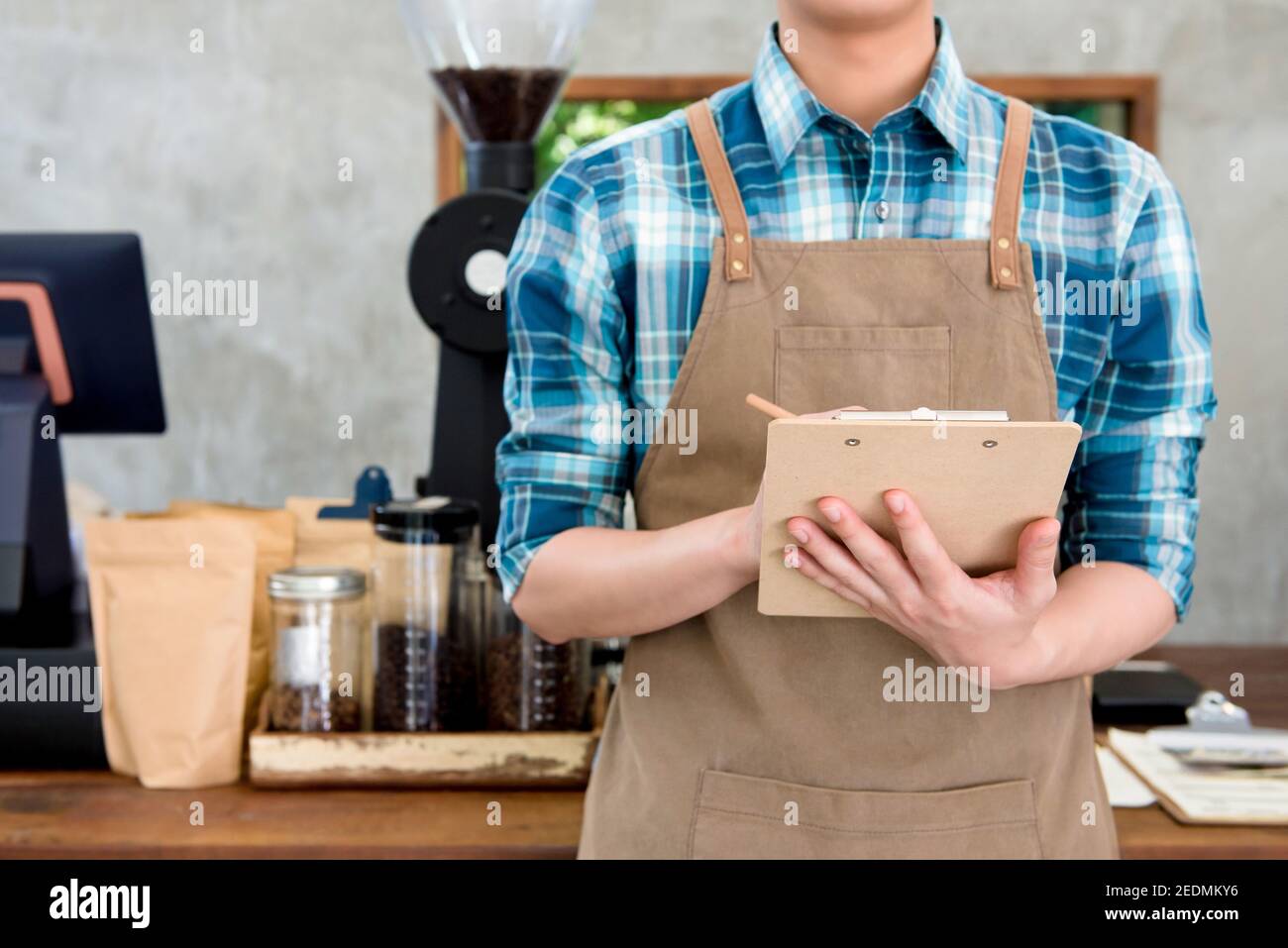 Young man entrepreneur taking order at coffee shop Stock Photo - Alamy