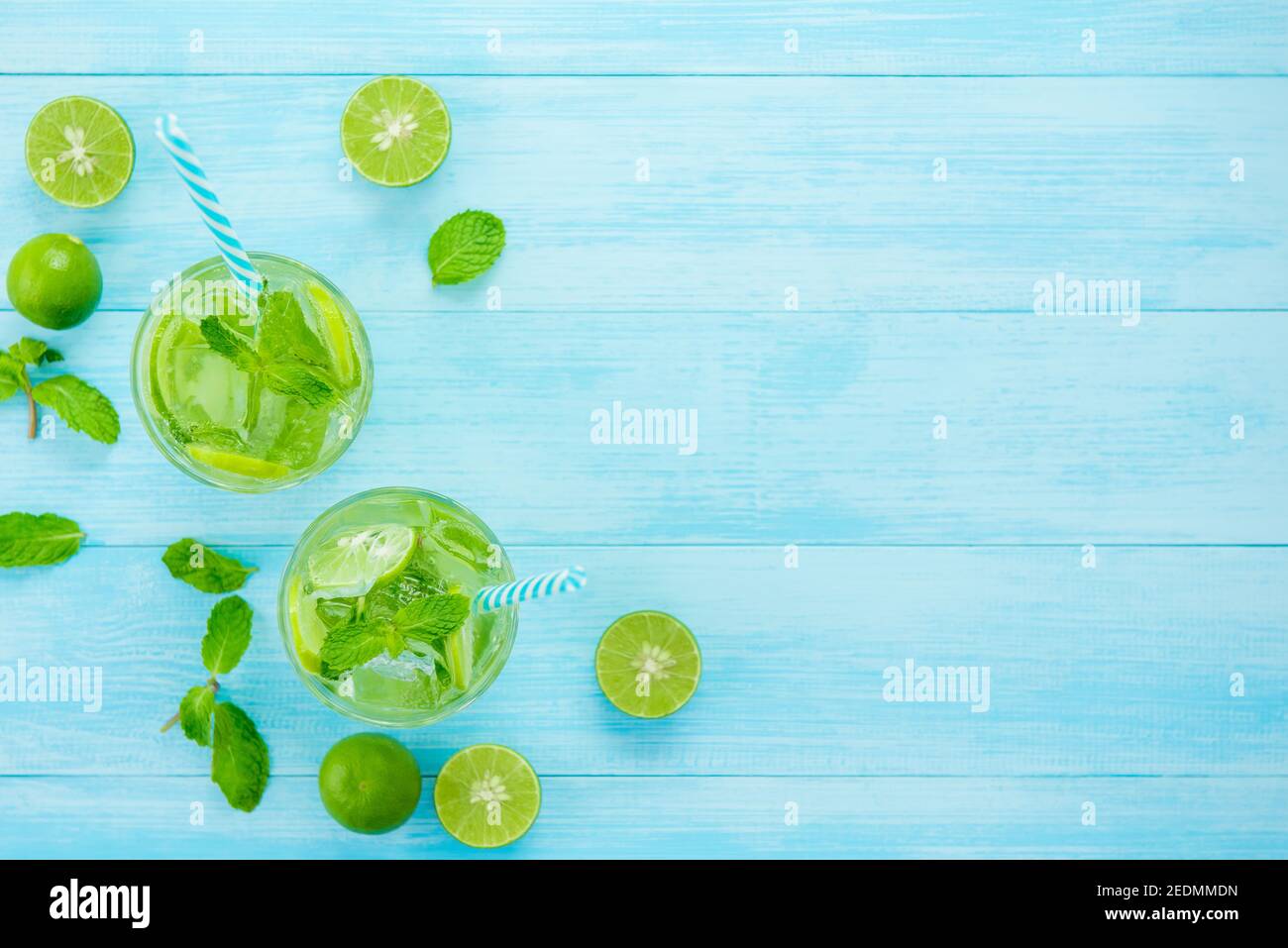 Refreshing Mojito cocktail drinks in the glasses with limes and mint ...