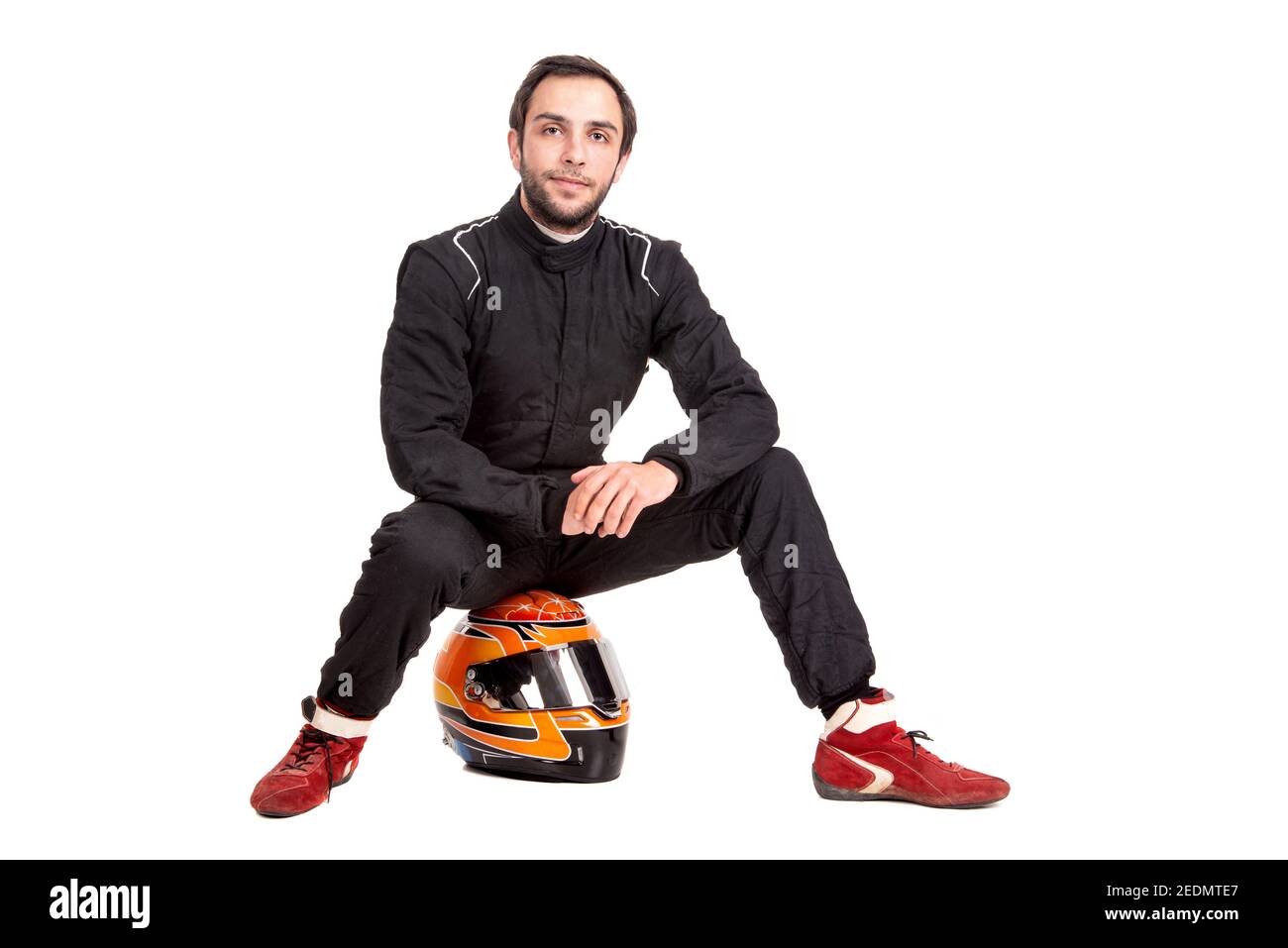 Racing driver posing with helmet isolated in white Stock Photo - Alamy
