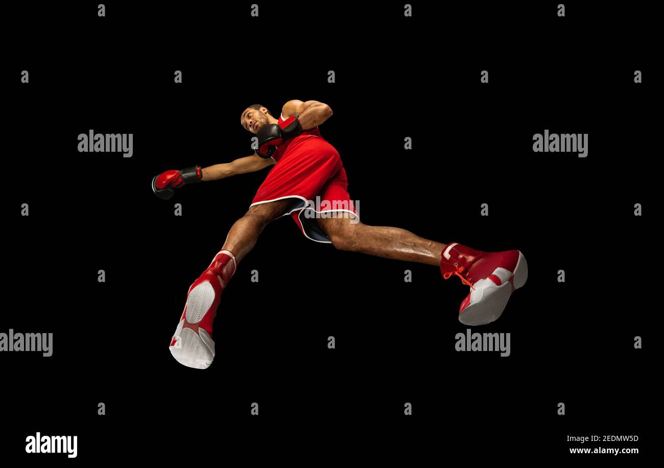 Young african-american professional boxer in action, motion isolated on ...