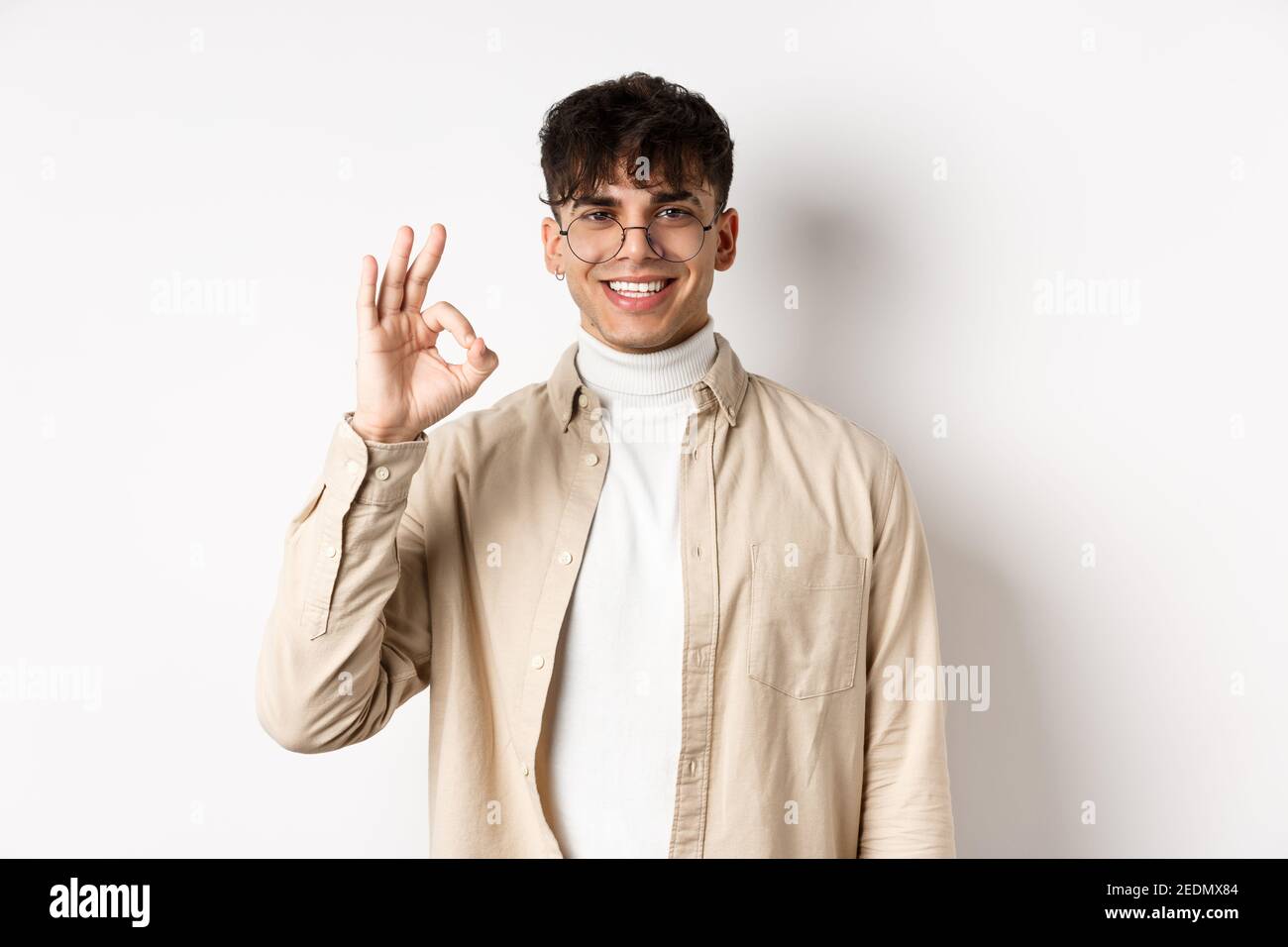 Image of handsome european man in glasses showing okay gesture, smiling ...
