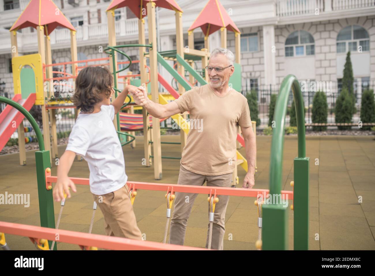 Father and son at the playground together Stock Photo - Alamy