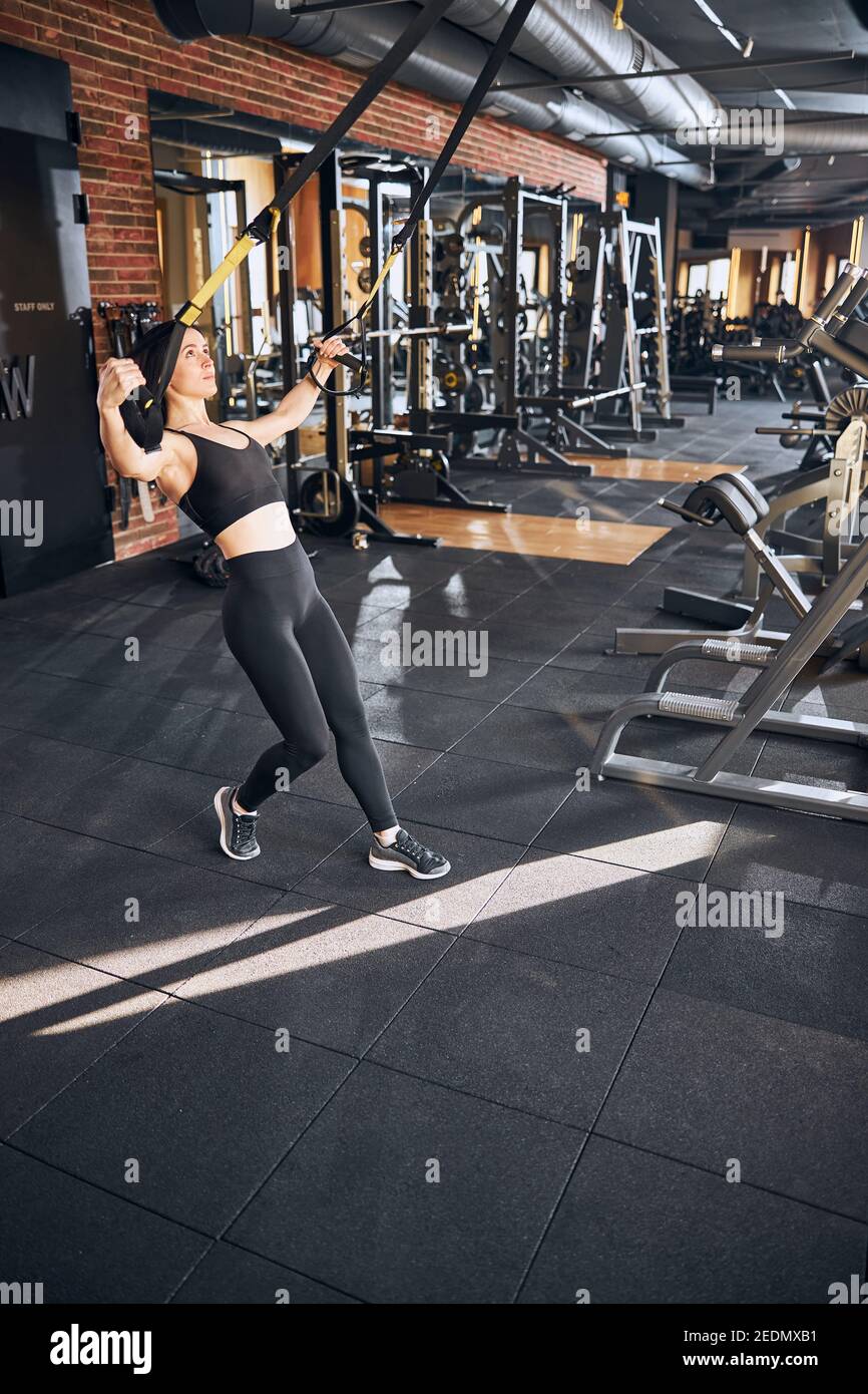 Slim female taking care of shape in gym Stock Photo - Alamy