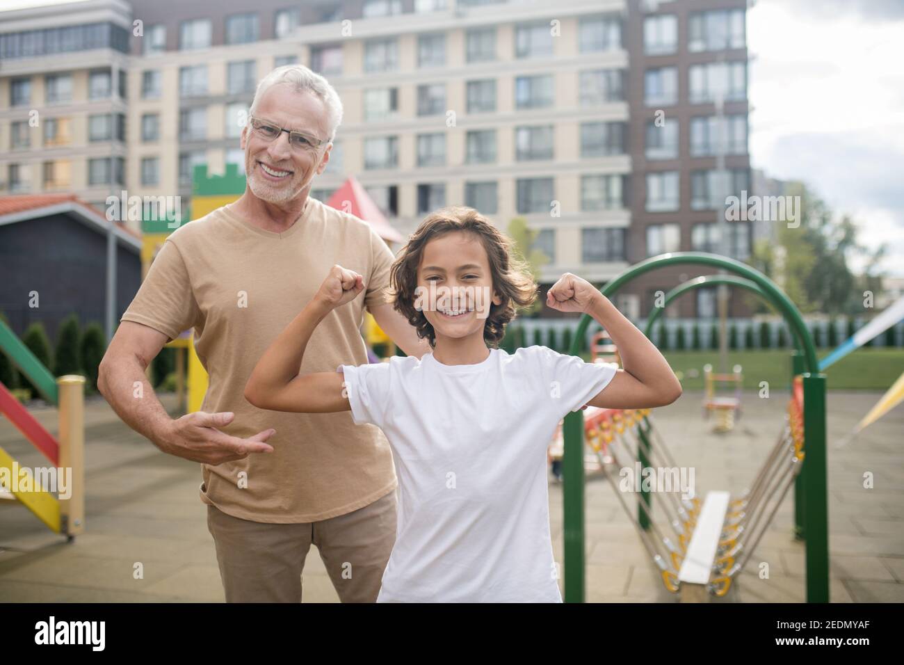 Father and son feeling happy and strong Stock Photo - Alamy