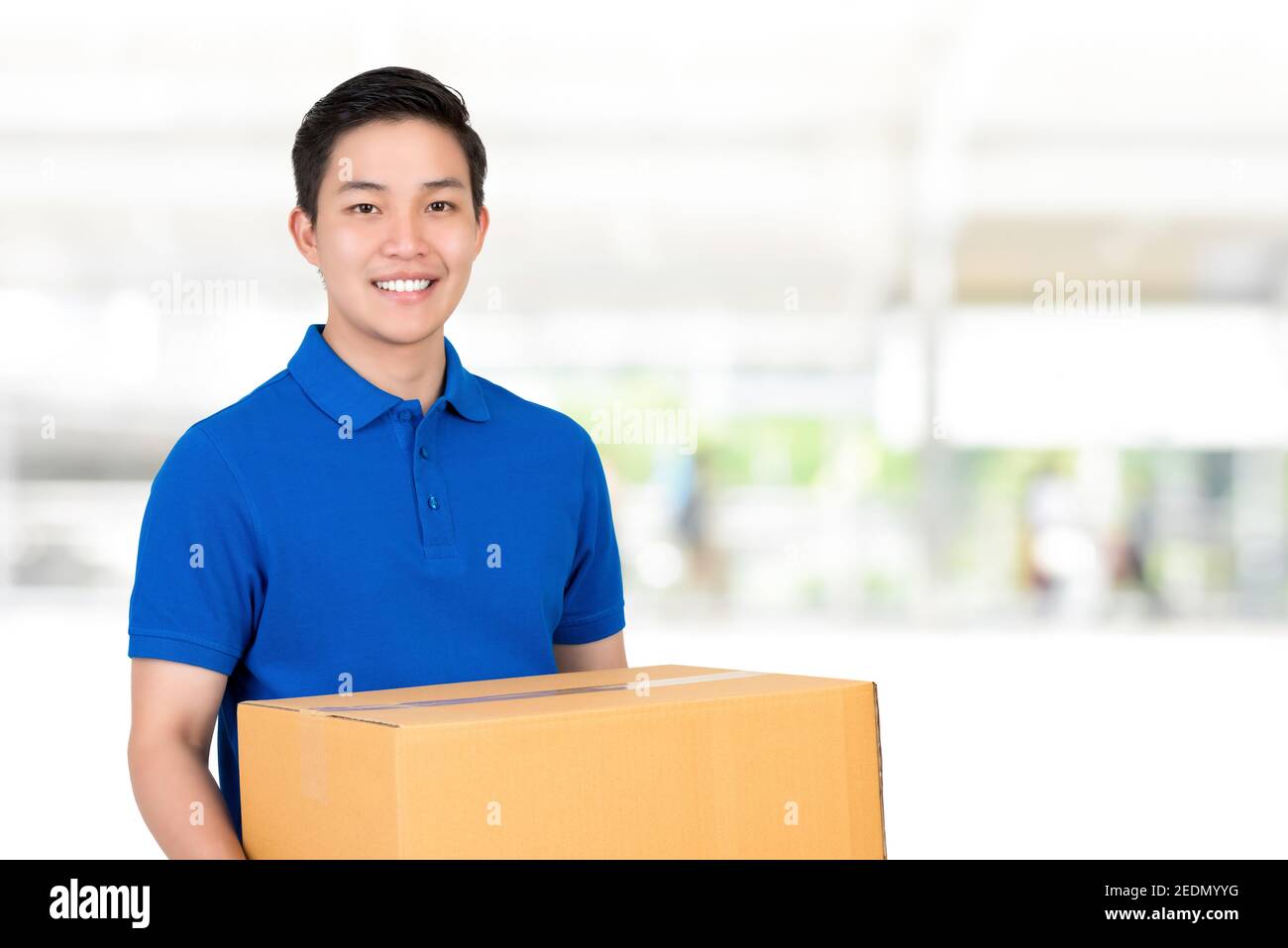 Handsome friendly smiling Asian delivery man in blue polo shirt ...