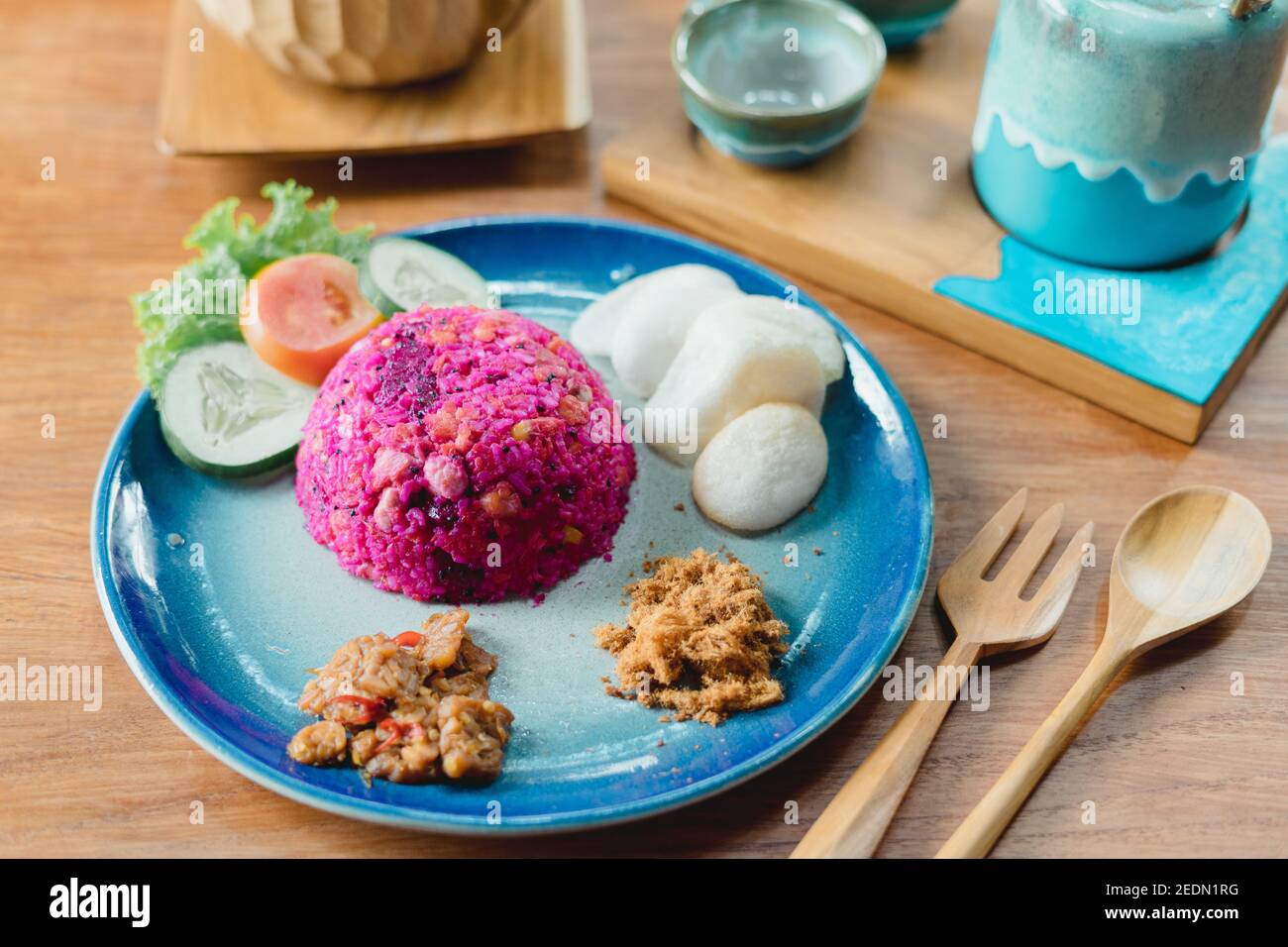 Purplish dragon fruit fried rice with tempe, vegetables and crackers ...