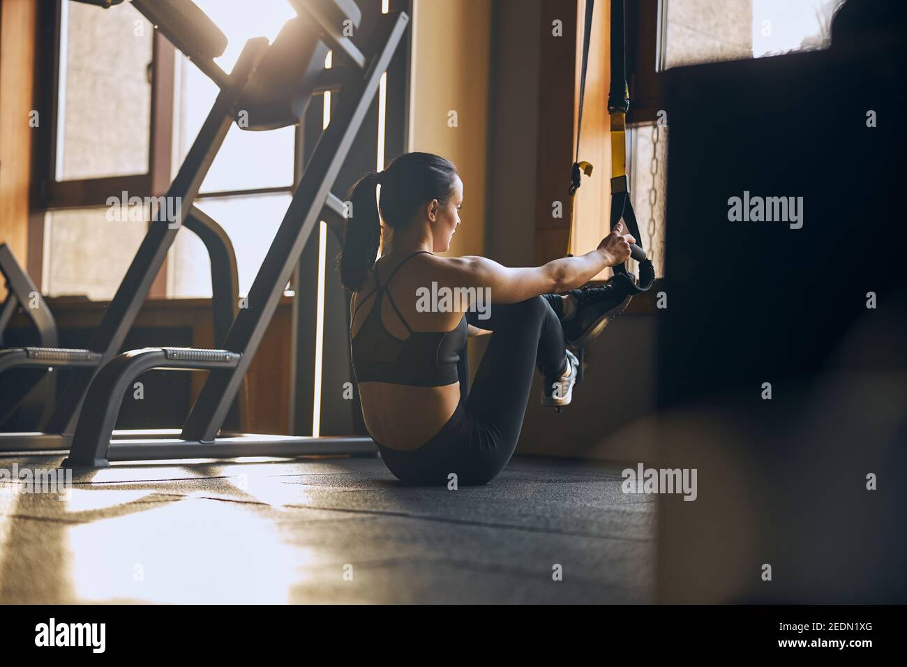 Fitness woman using suspension hi-res stock photography and images - Alamy