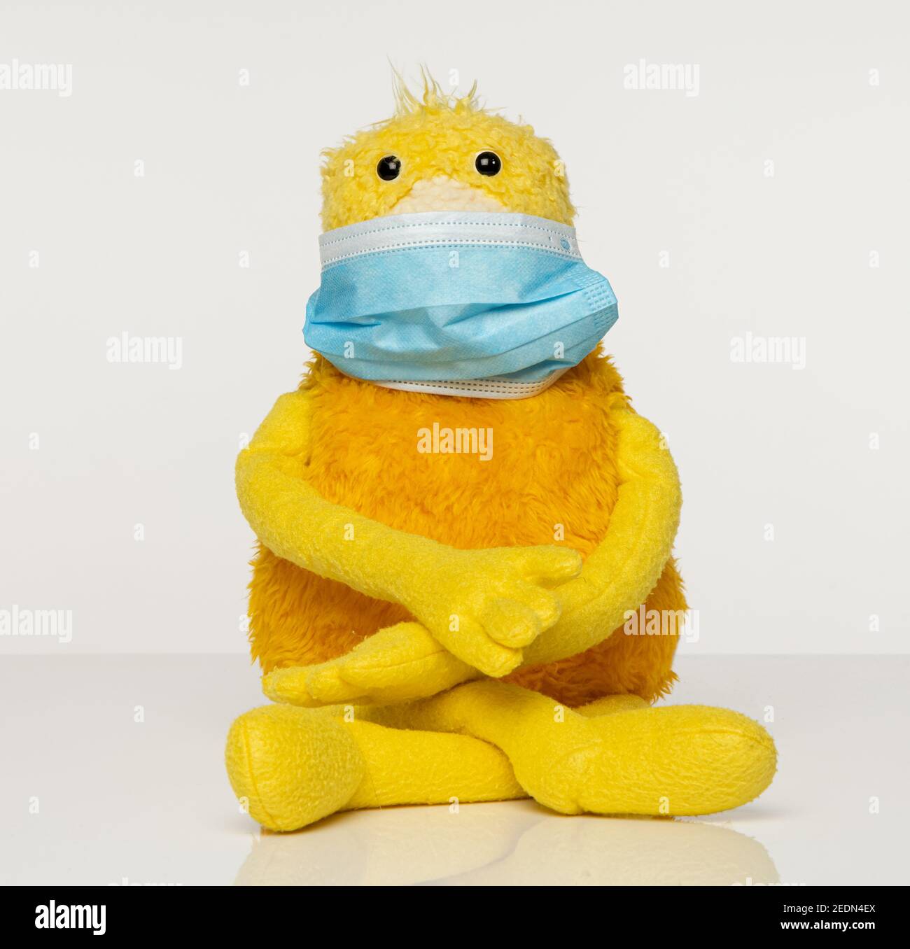 Isolated Flat Eric puppet character wearing a face mask against a plain ...