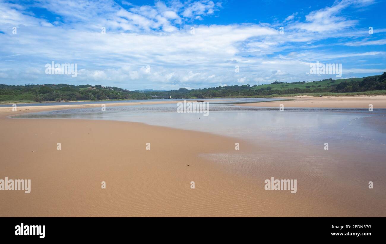 Beach river mouth flowing waters into ocean standing middle outward ...