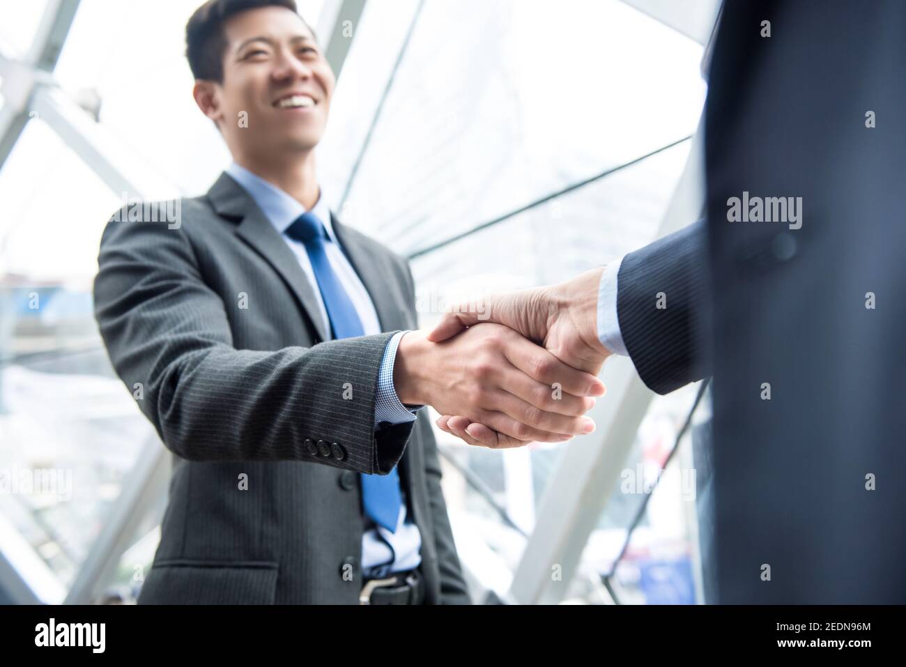 Young businessman leader making handshake with partner - greeting ...