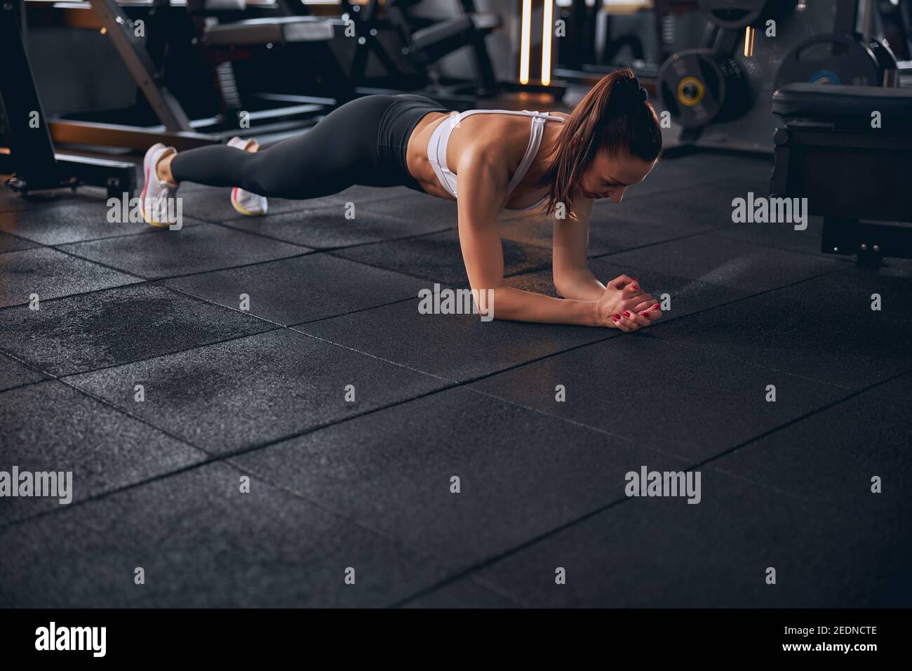 Beautiful slim woman training core in gym Stock Photo - Alamy