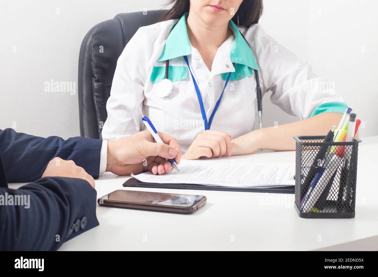 The patient signs a document for consent to anesthesia and surgery ...