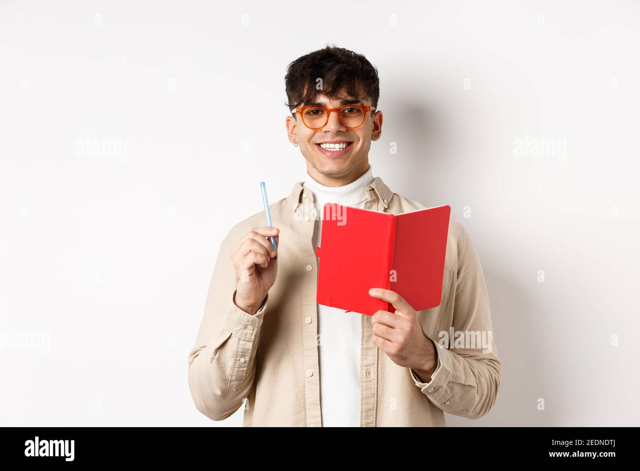 Happy person in glasses writing in journal, holding pen and diary ...